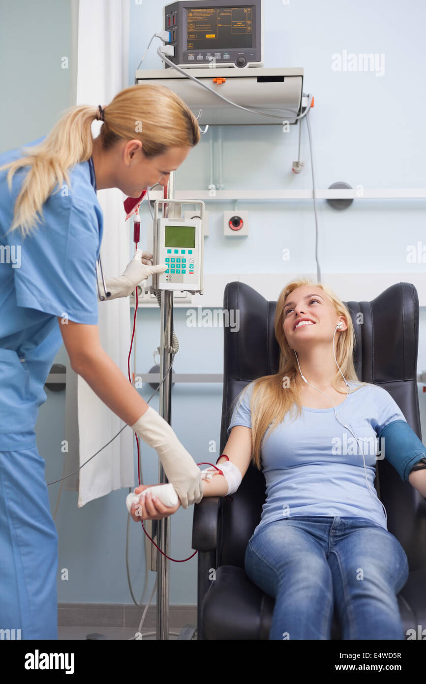 Nurse taking the pulse of a blood donor Stock Photo - Alamy