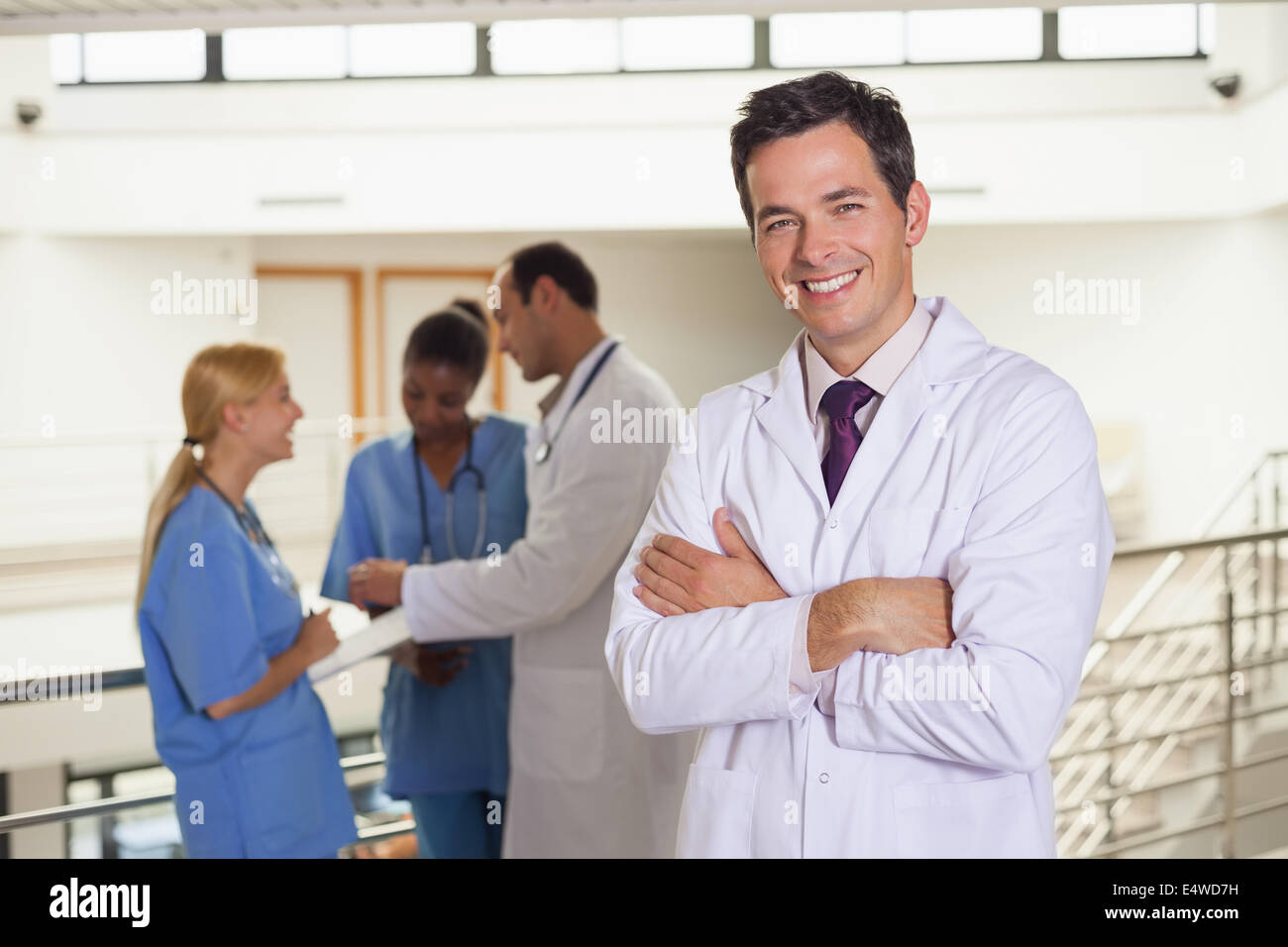 Doctor next to medical team Stock Photo - Alamy