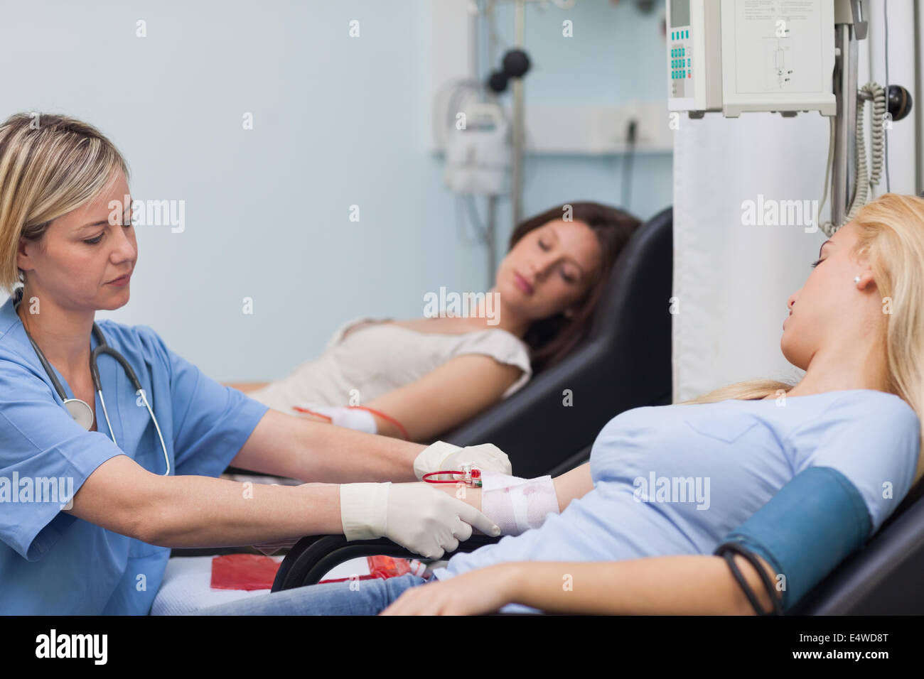 Nurse taking care of a patient Stock Photo - Alamy