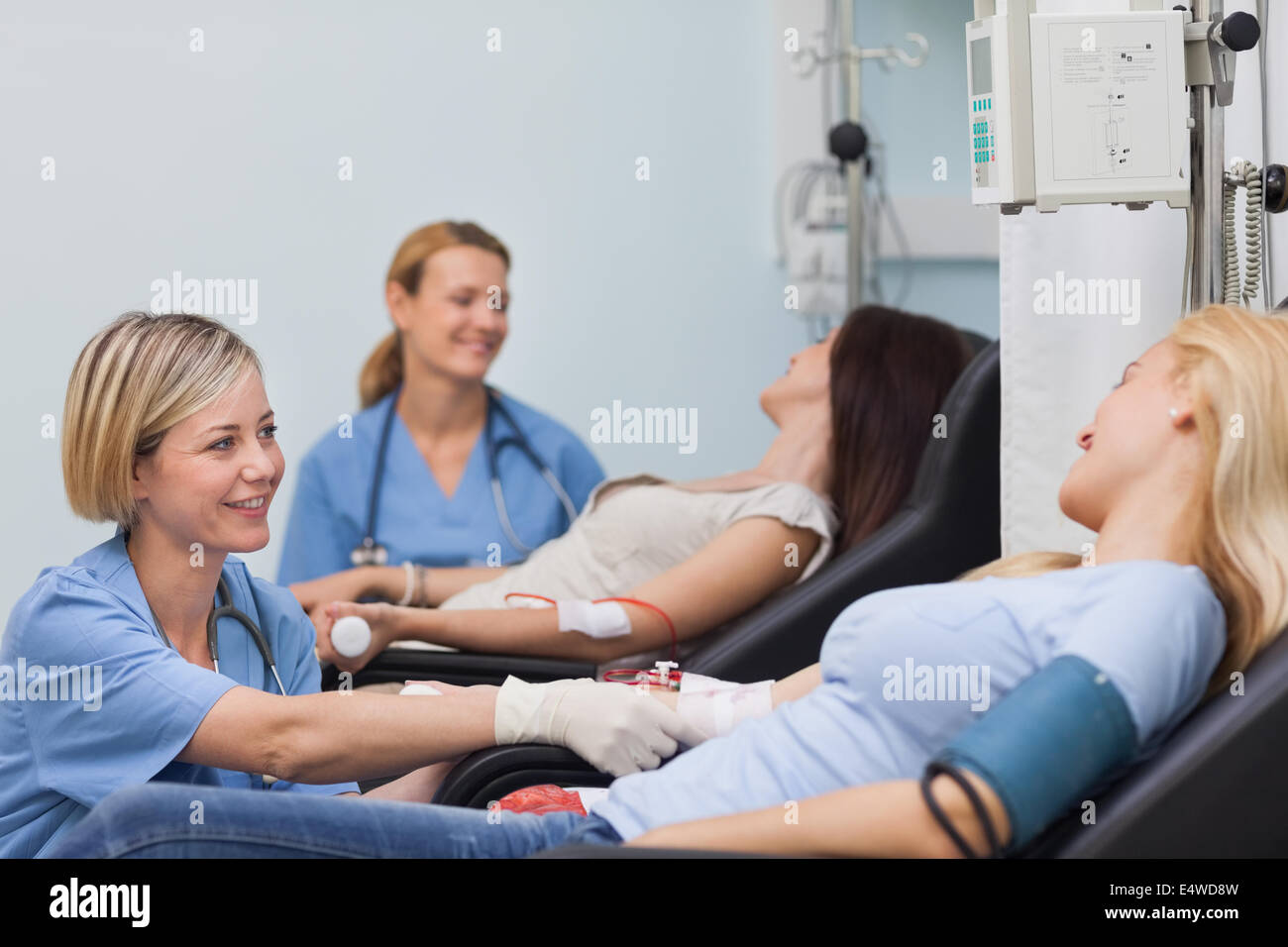 Nurse looking after a patient Stock Photo - Alamy