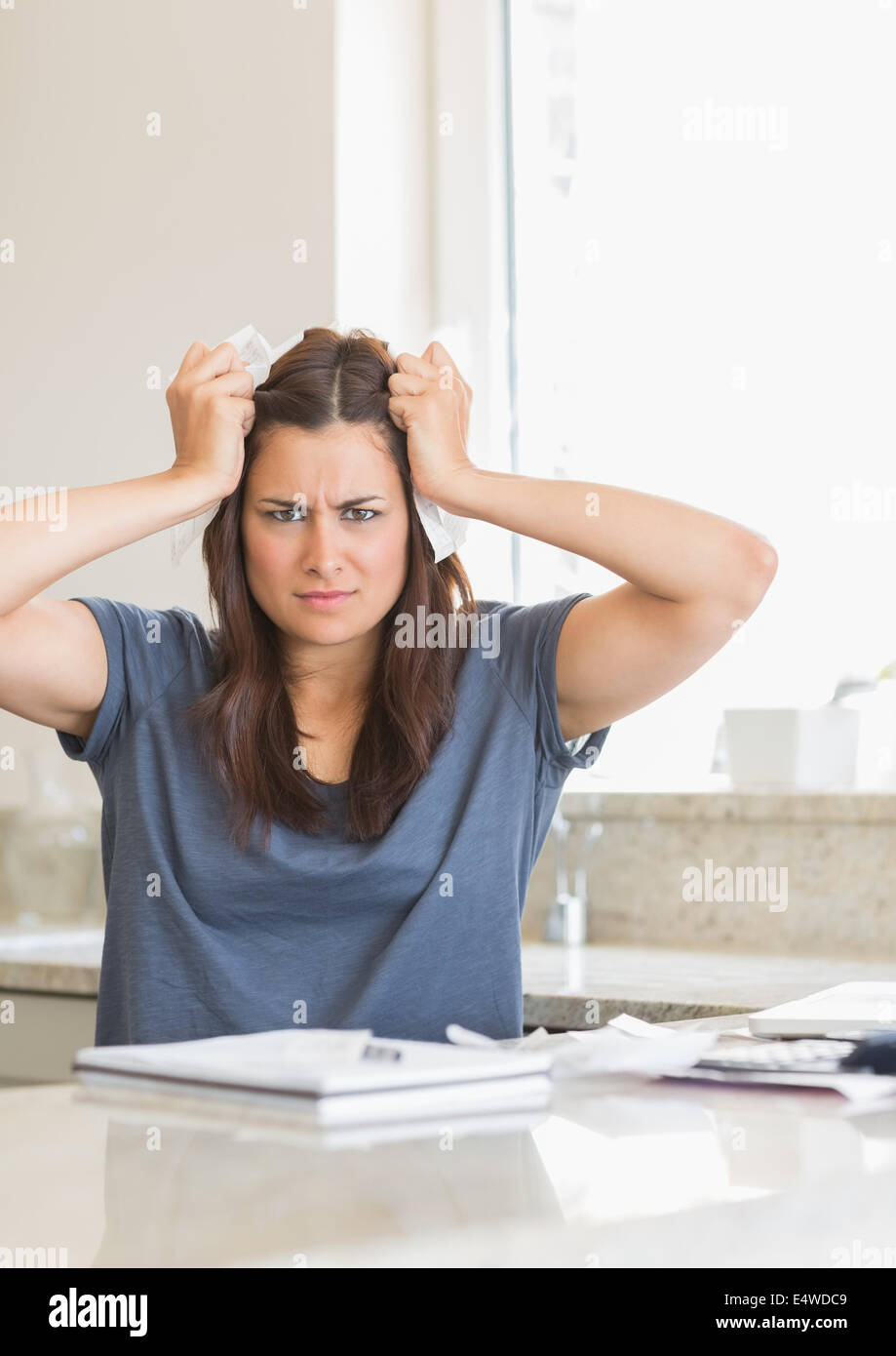 Woman feeling angry about bills Stock Photo - Alamy