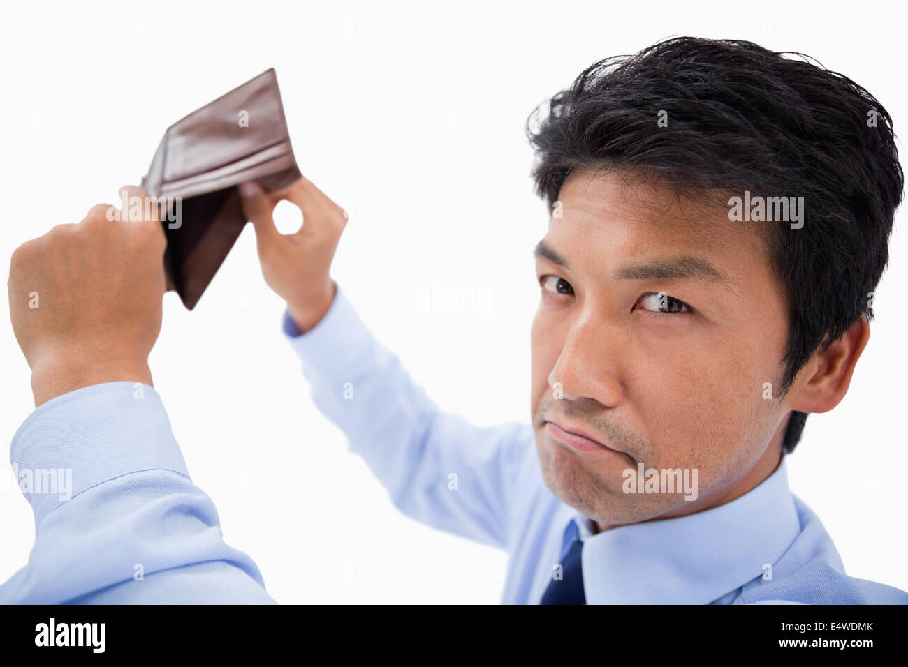 Broke businessman showing his empty wallet Stock Photo - Alamy