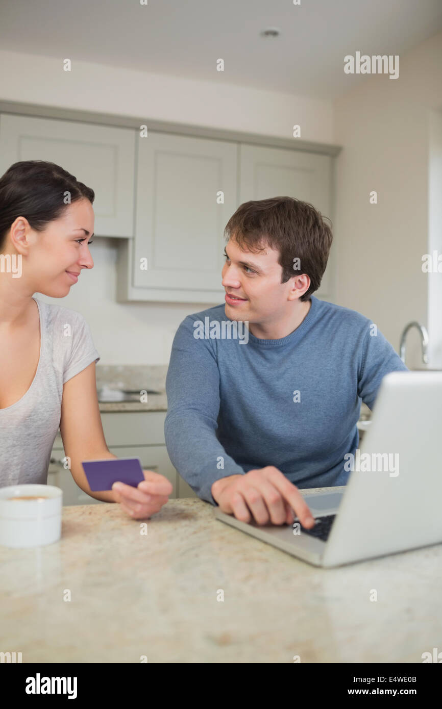 Couple using credit card online Stock Photo - Alamy