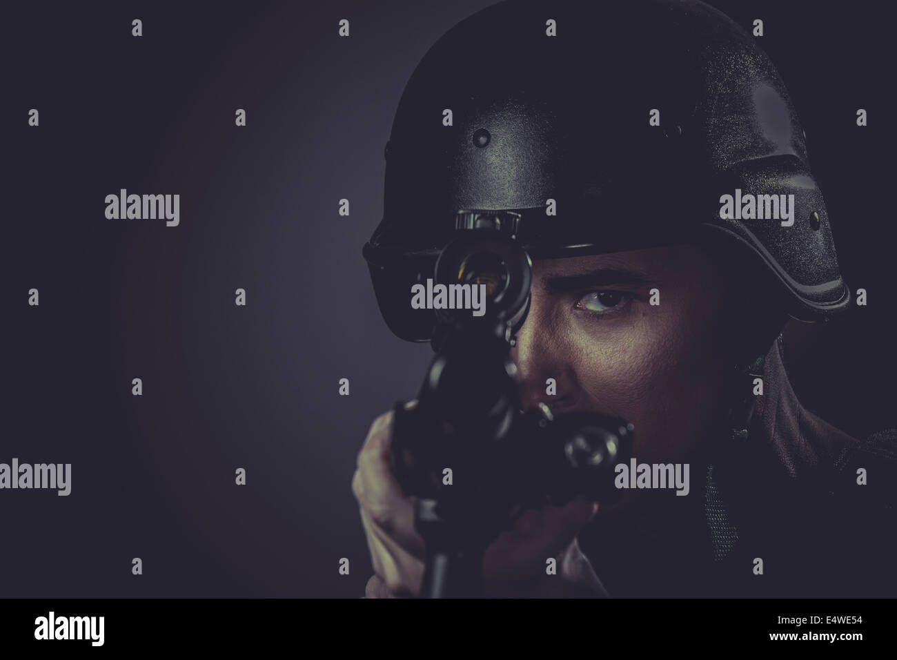 Police, paintball sport player wearing protective helmet aiming pistol ...