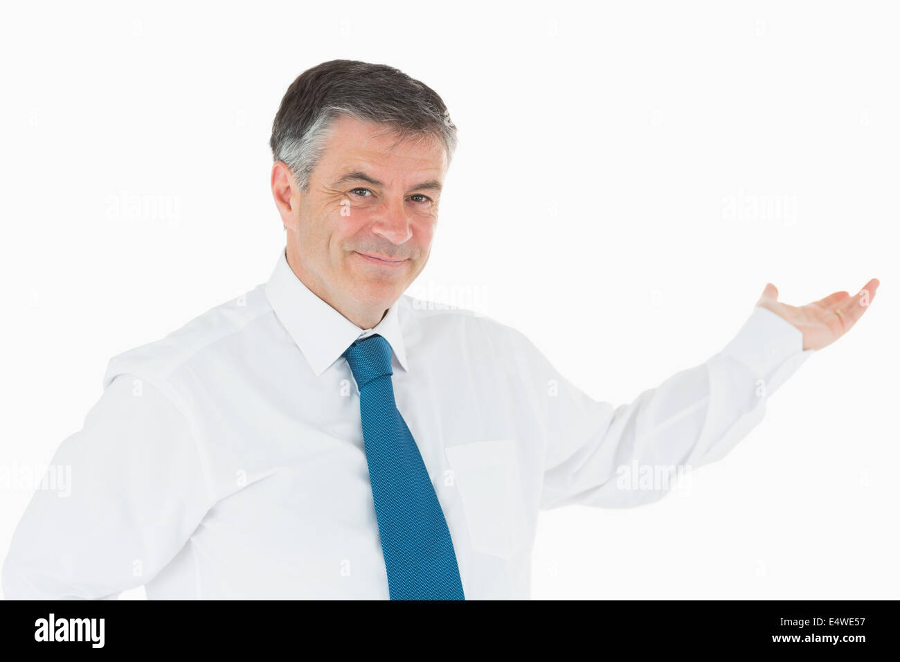Smiling businessman holding out his hand Stock Photo - Alamy