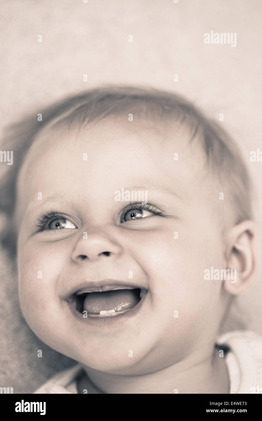Smiling baby lying on back Stock Photo - Alamy