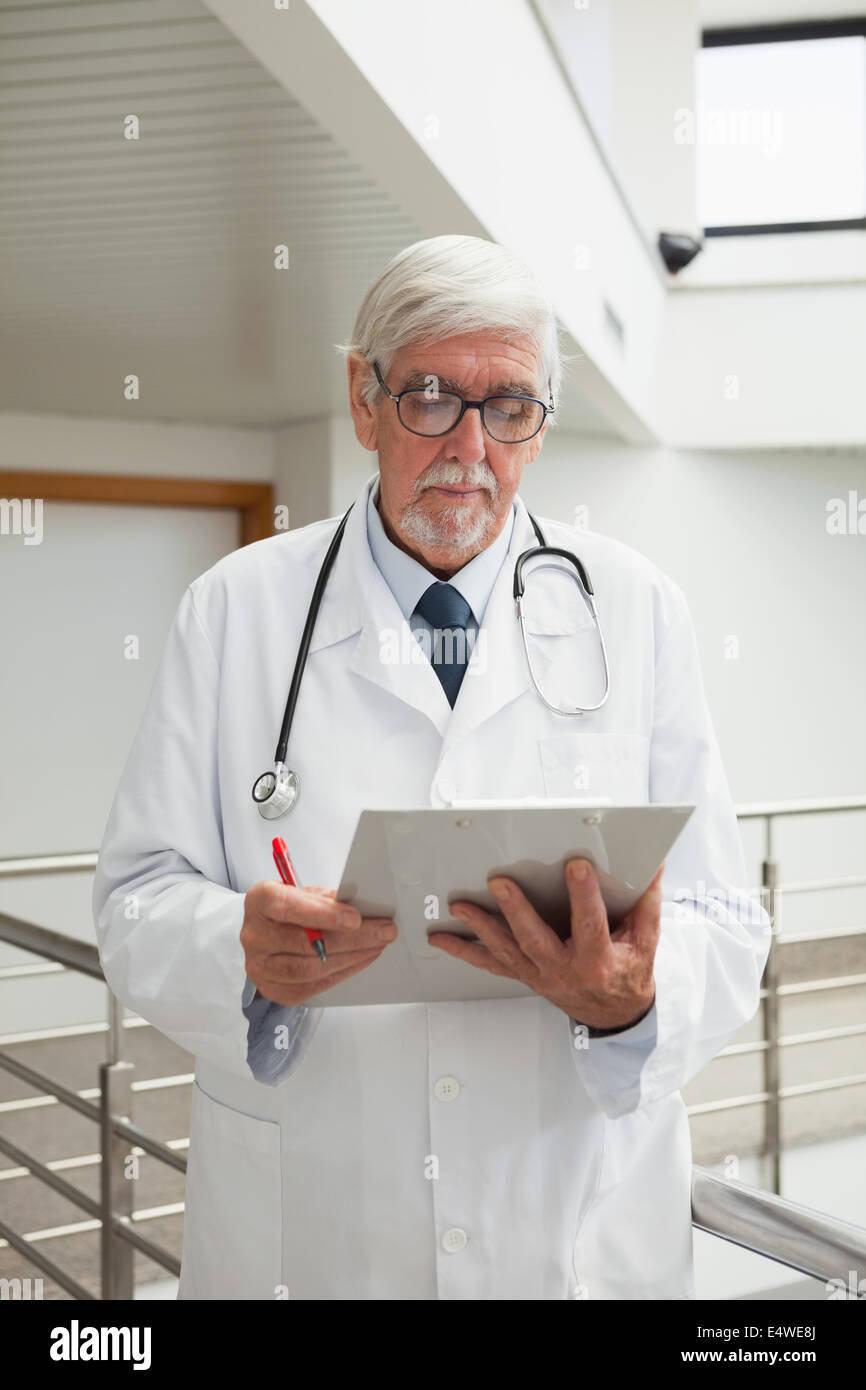 Doctor looking at patient files Stock Photo - Alamy