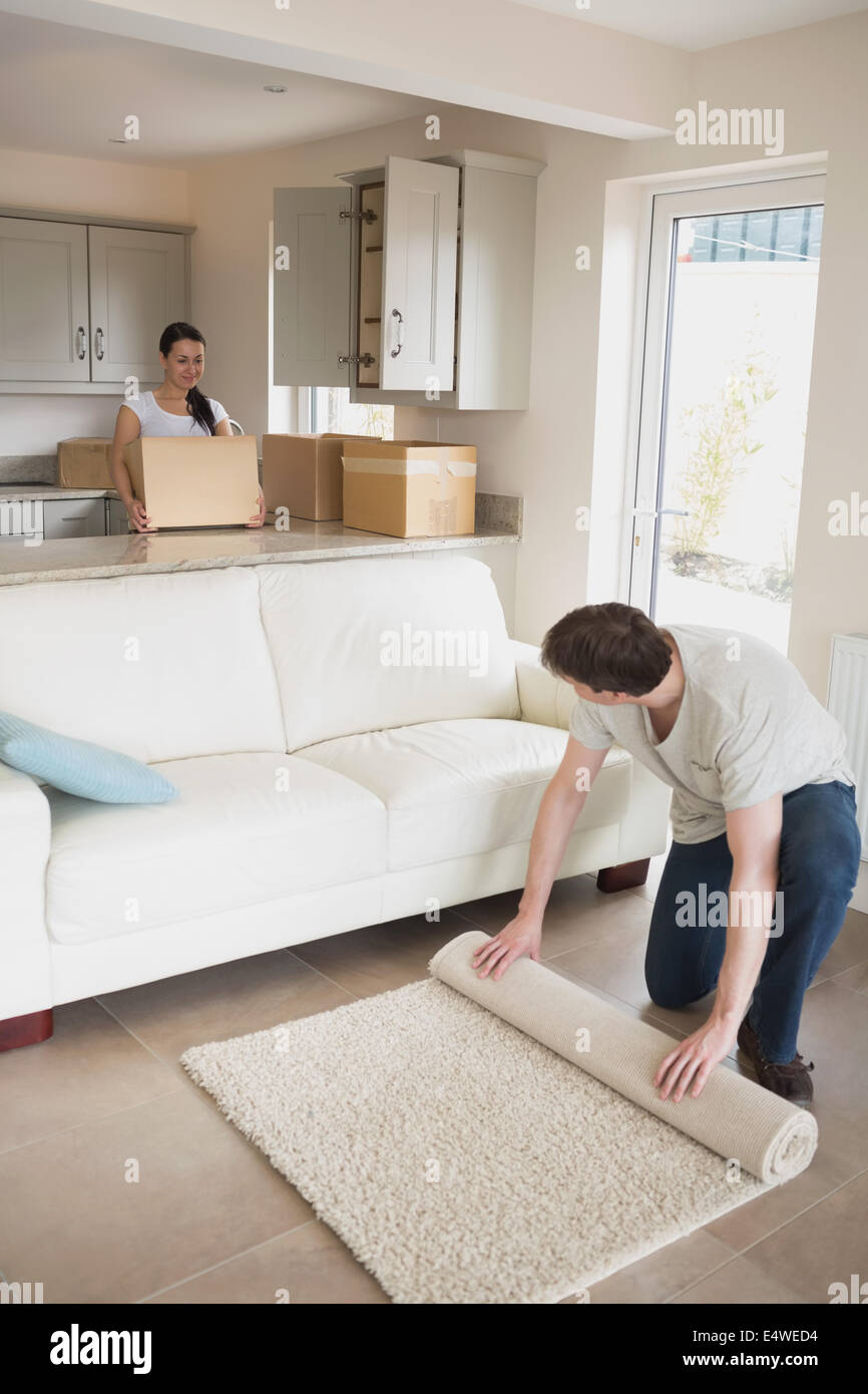 Young people furnishing the house Stock Photo - Alamy