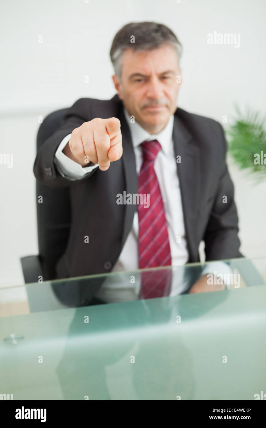 Serious businessman pointing Stock Photo - Alamy