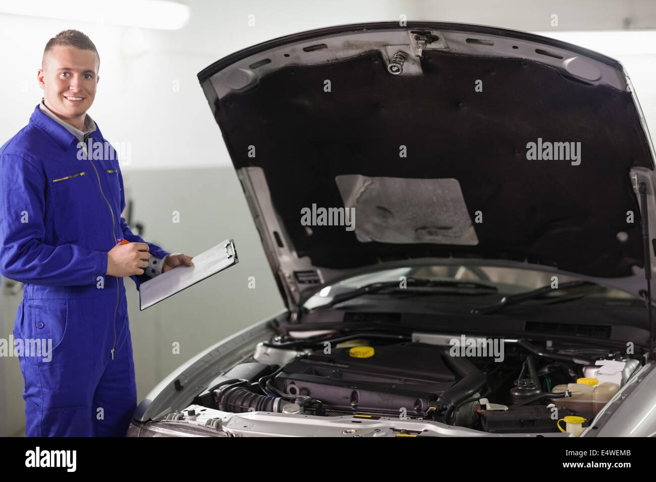 Happy mechanic man clipboard hi-res stock photography and images - Alamy