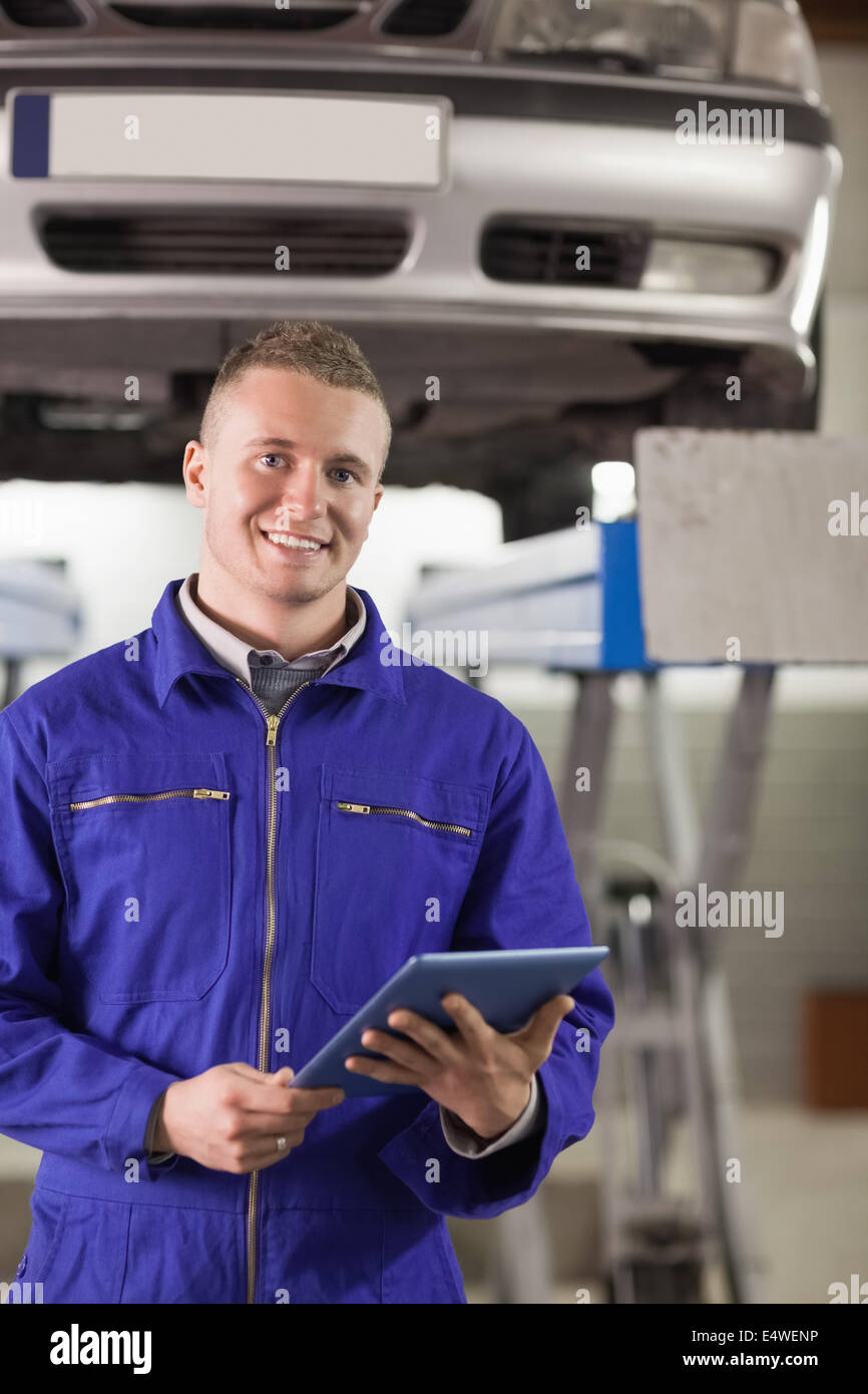 Mechanic holding tablet computer hi-res stock photography and images ...