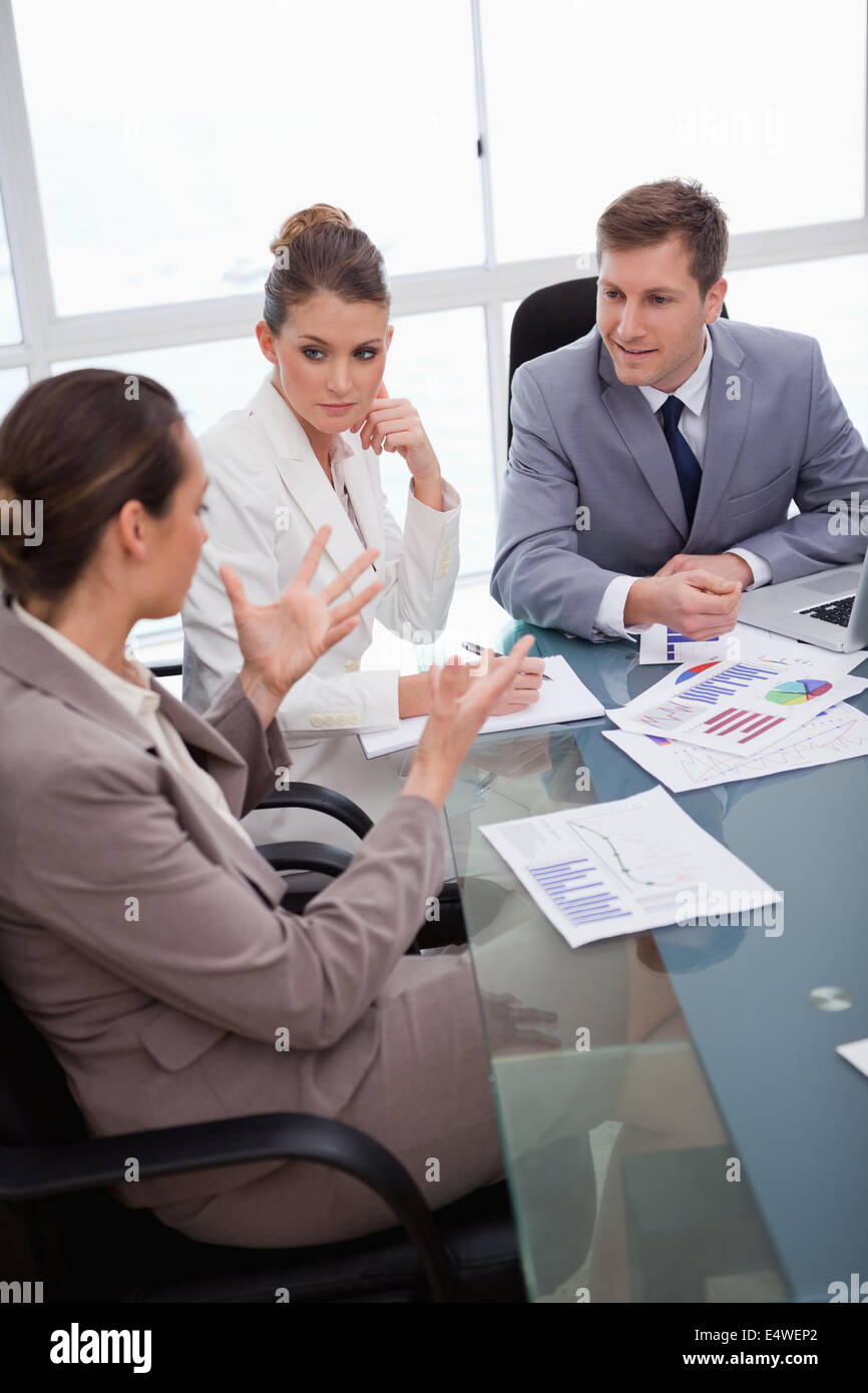 Business team talking about survey Stock Photo - Alamy
