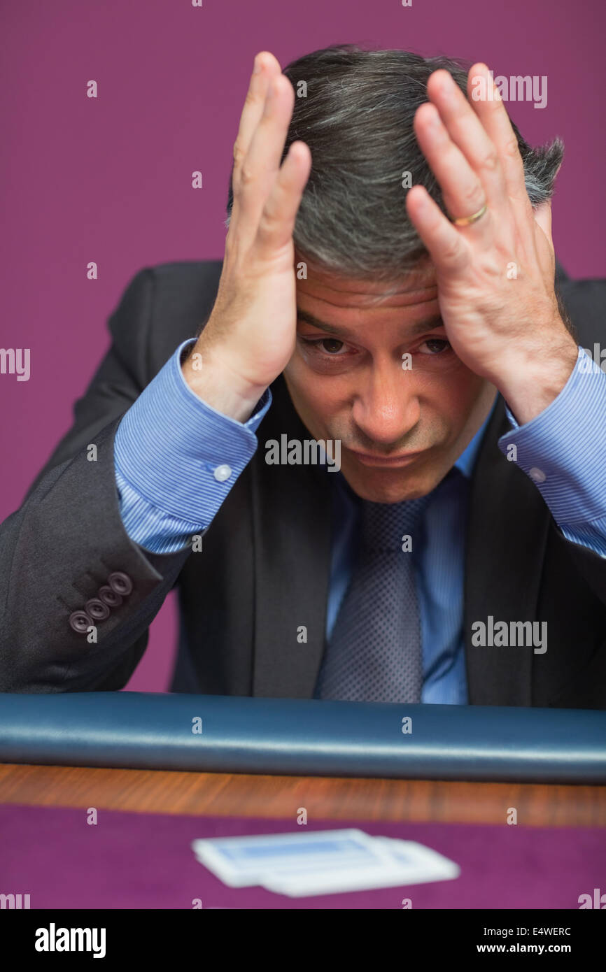 Man with head in hands Stock Photo - Alamy