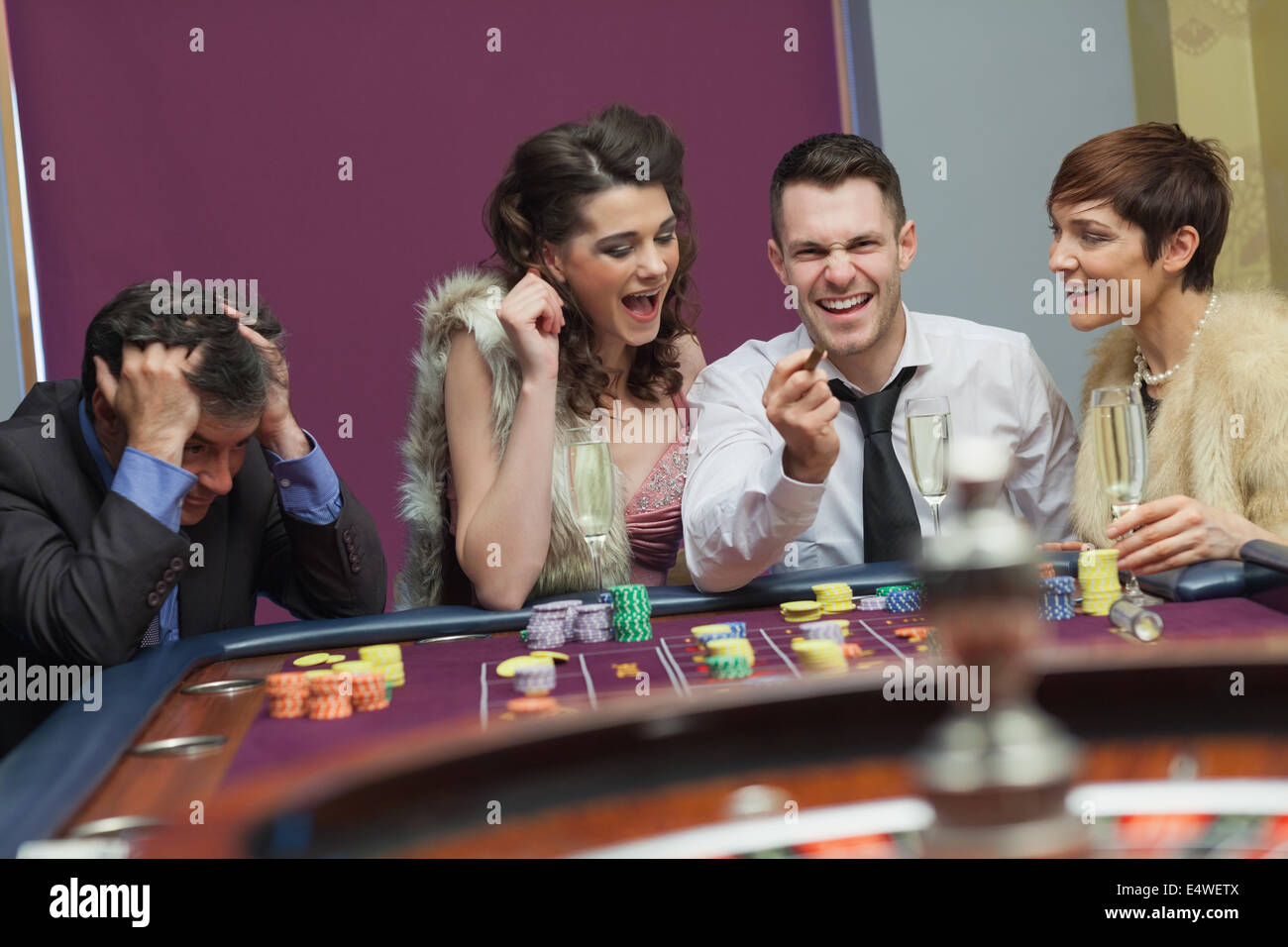 Winner and loser at roulette table Stock Photo - Alamy