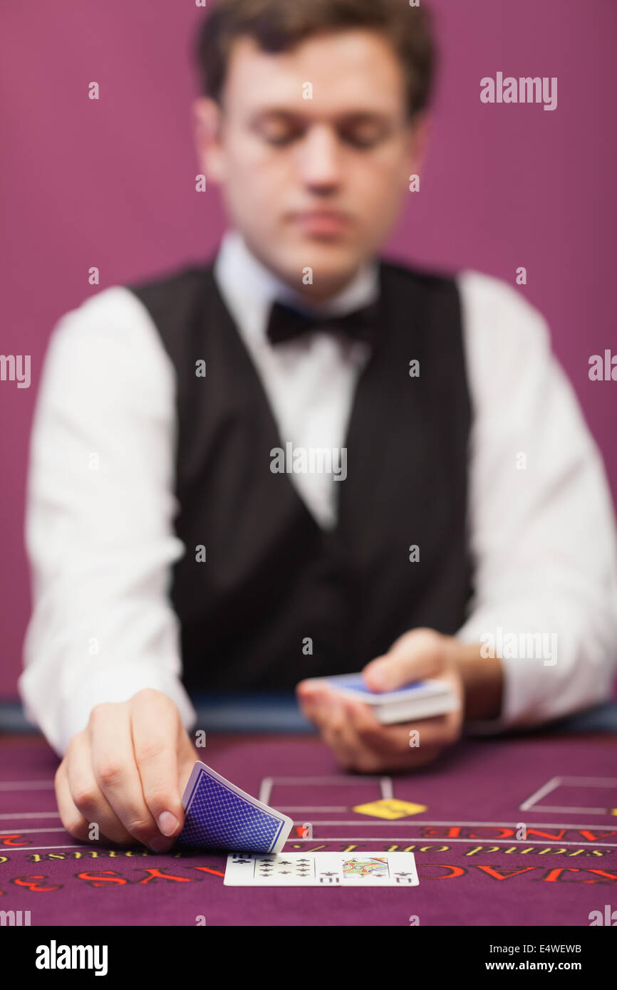 Dealer in a casino distributing cards Stock Photo - Alamy