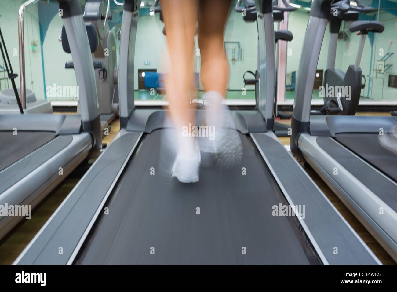 Feet running on a treadmill Stock Photo - Alamy