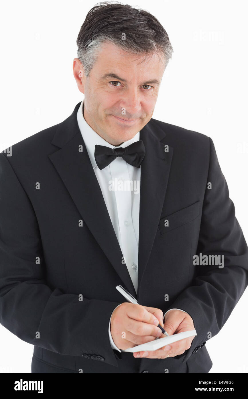 Waiter writing orders and smiling Stock Photo - Alamy