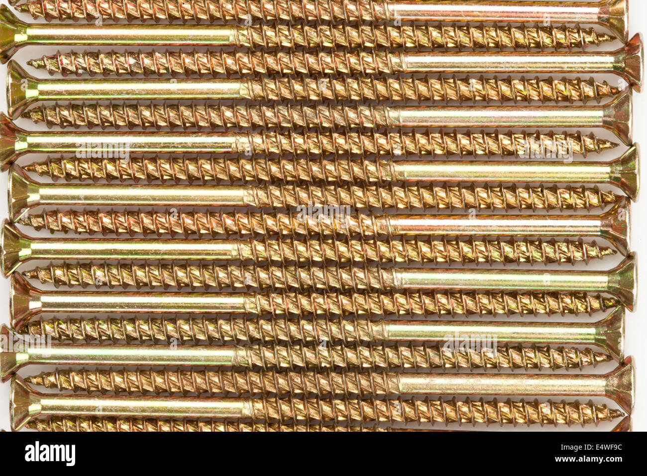 Well-ordered golden screws Stock Photo - Alamy