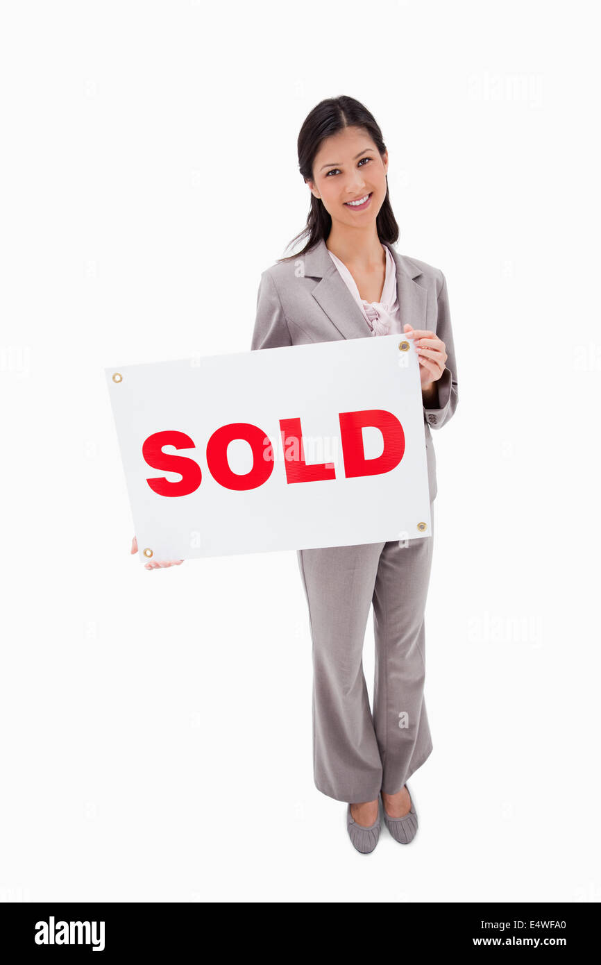 Real estate agent with sold sign Stock Photo - Alamy