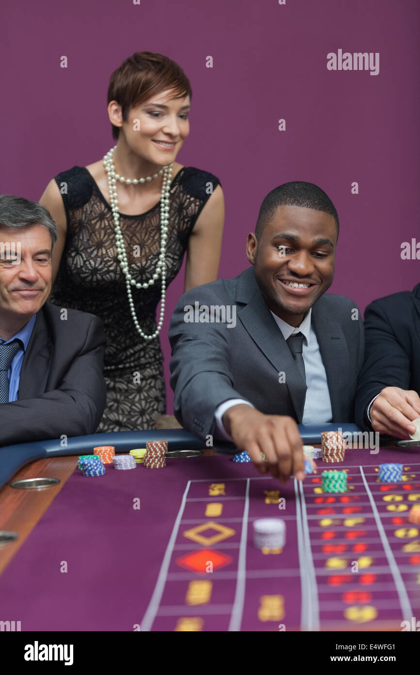 Bets being placed at roulette table Stock Photo - Alamy