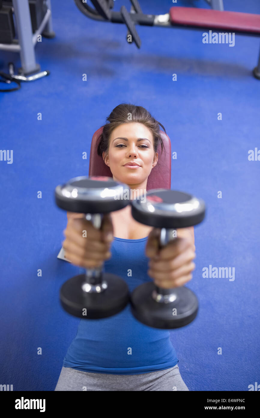 Woman straining to lift weights Stock Photo - Alamy