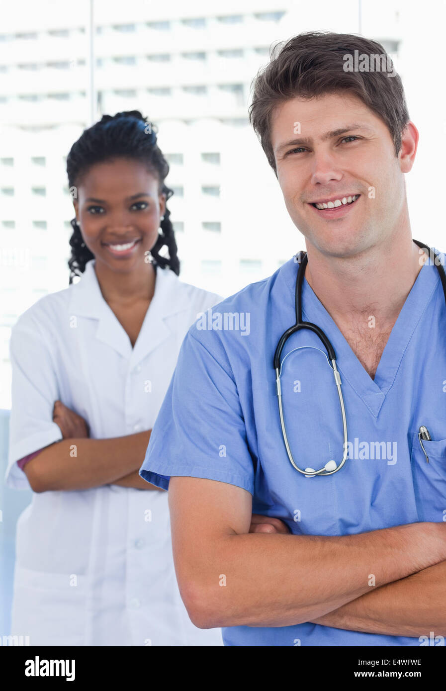 Two doctors standing arms hi-res stock photography and images - Alamy