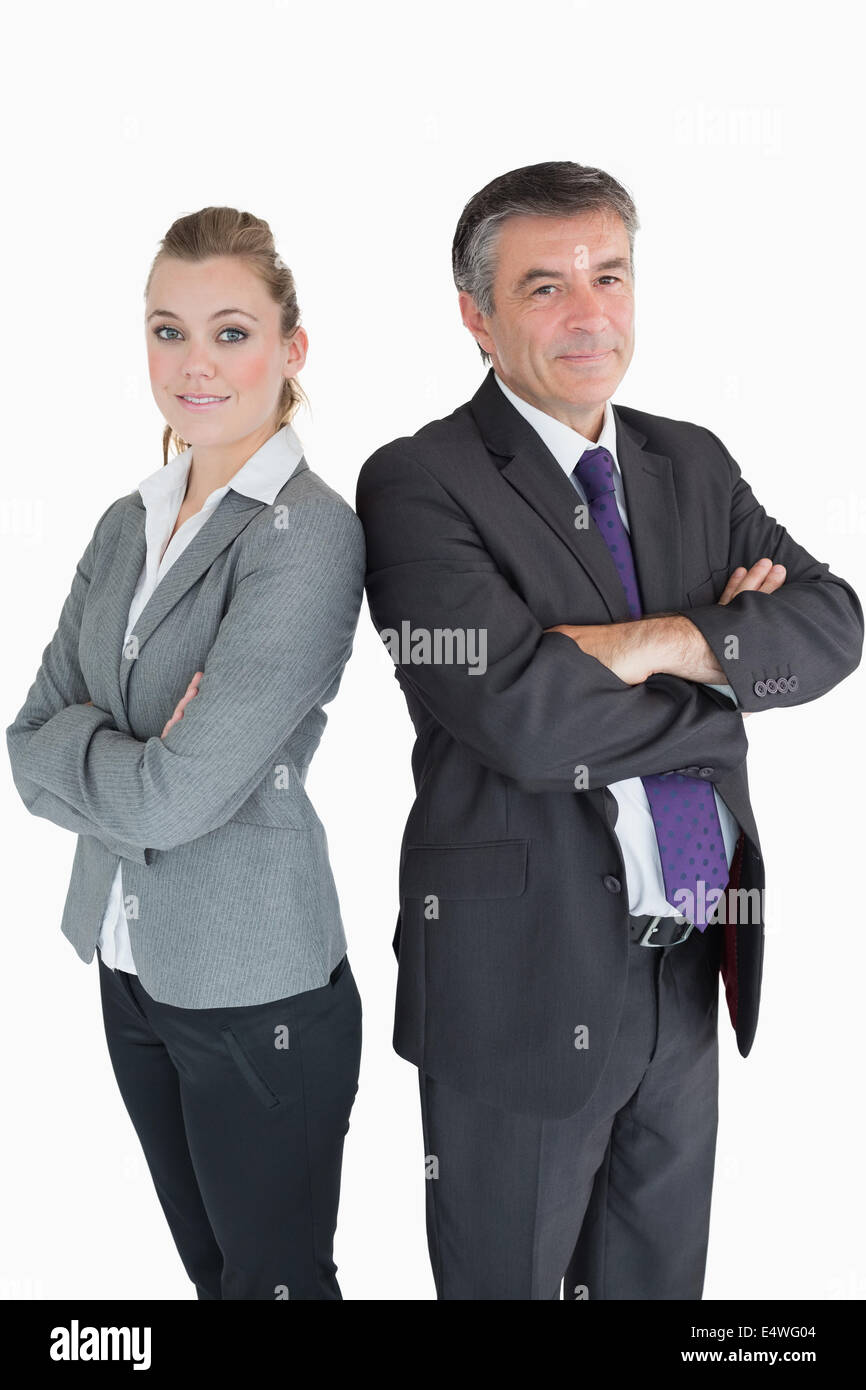 Smiling business people back to back Stock Photo - Alamy