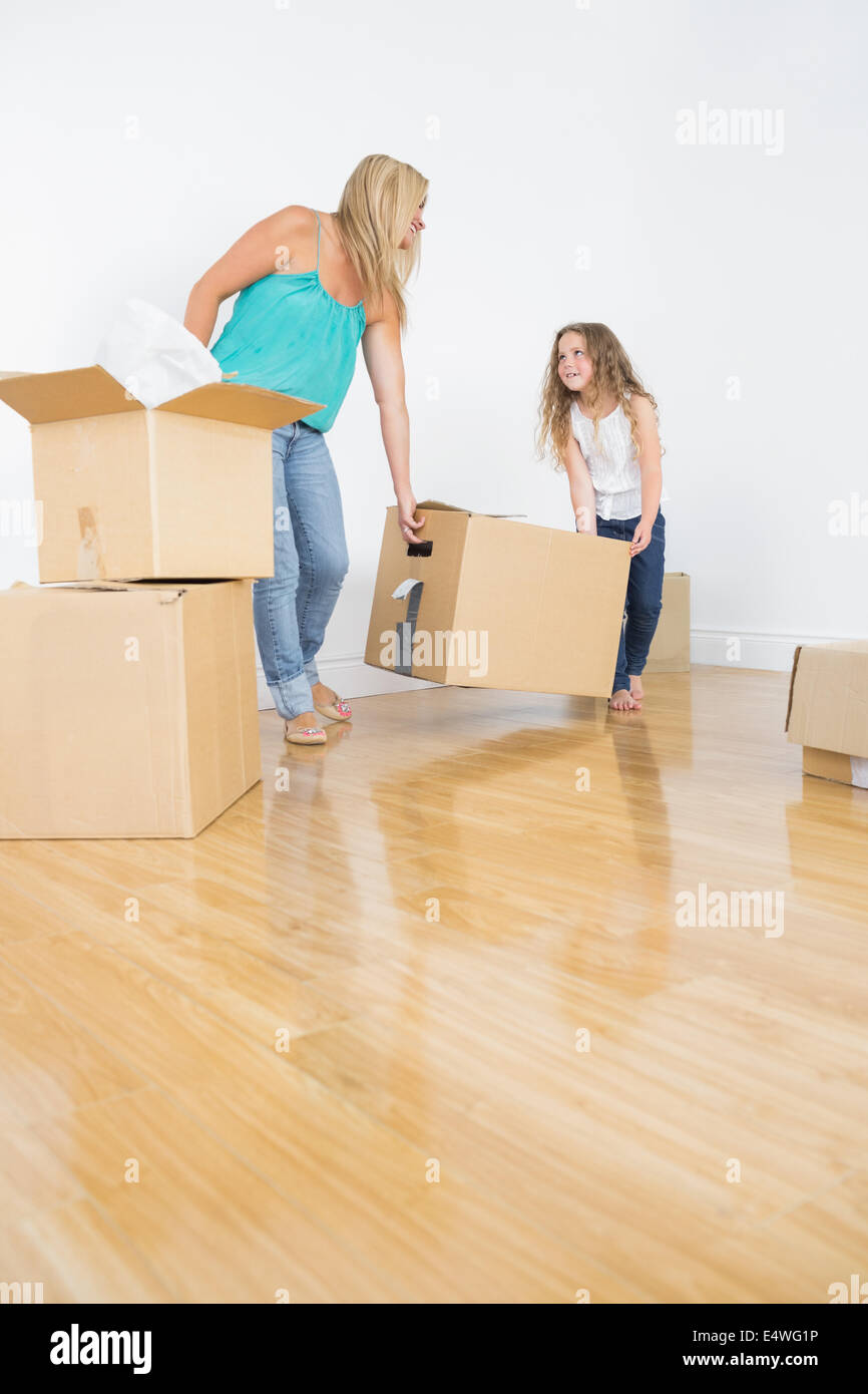 Mother and daughter lifting moving boxes Stock Photo - Alamy