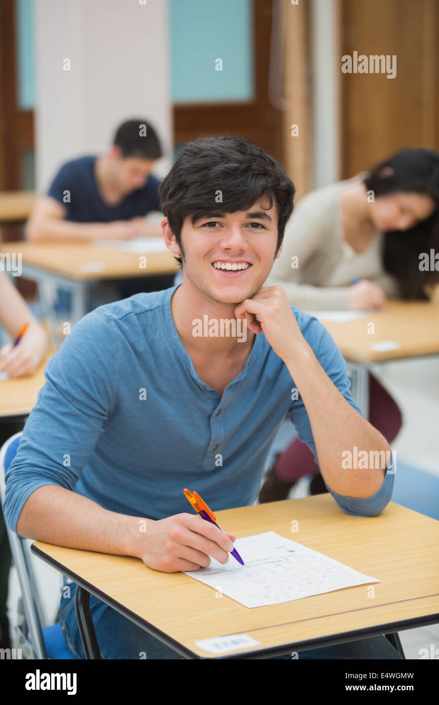 Student smiling during exam Stock Photo - Alamy