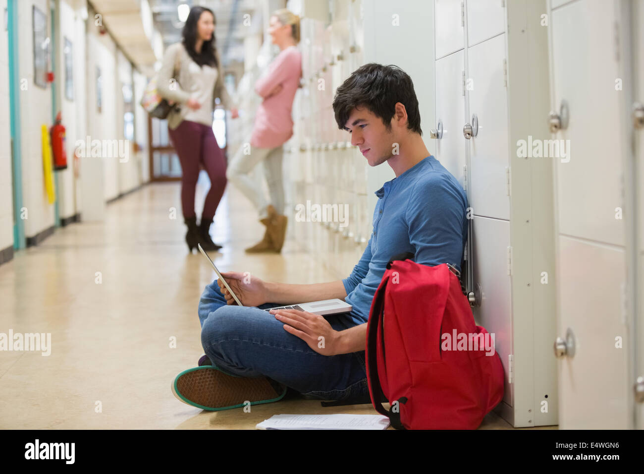Concentrated student sitting on the floor Stock Photo - Alamy