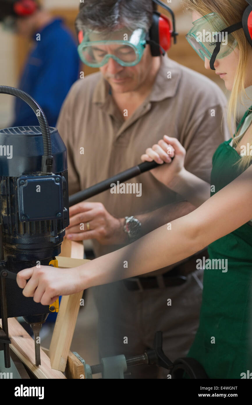 Woman standing at a drill machine Stock Photo - Alamy