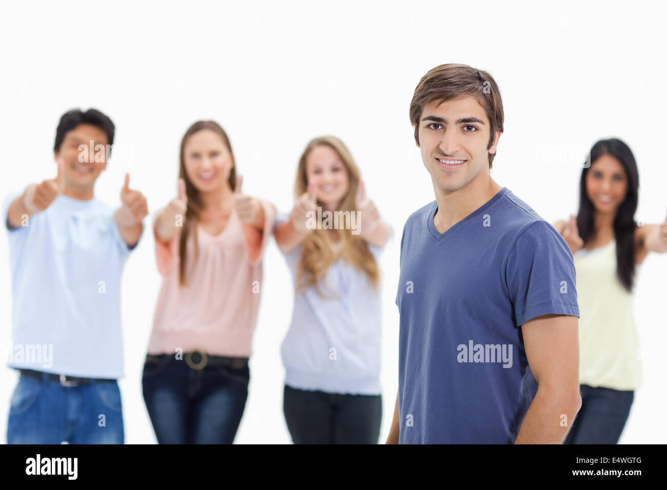 Man smiling with people approving behind him Stock Photo - Alamy