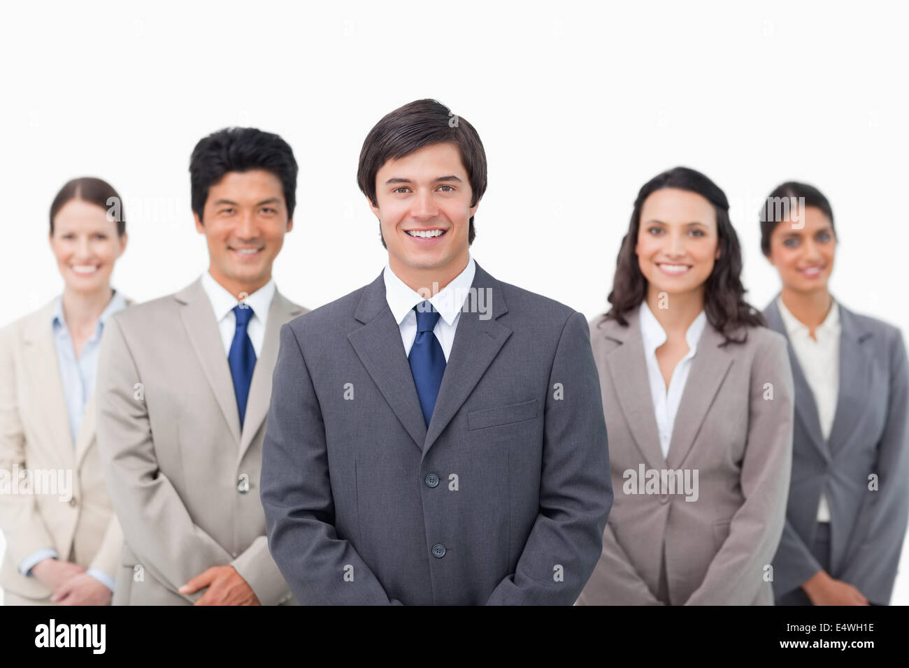 Smiling young salesteam standing Stock Photo - Alamy