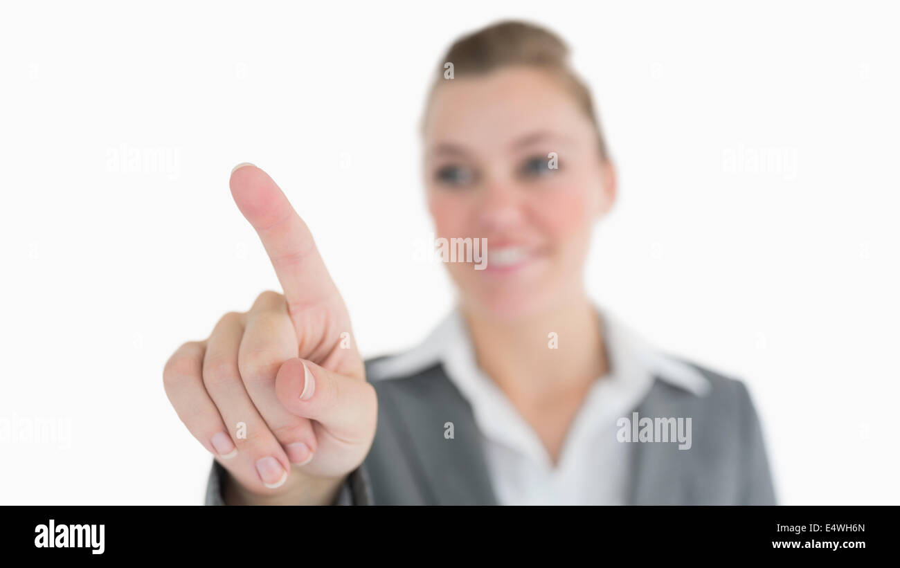 Smiling woman pointing in the air Stock Photo - Alamy