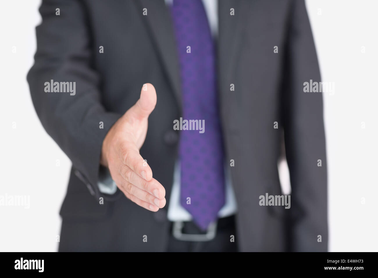 Businessman holding hand out Stock Photo - Alamy