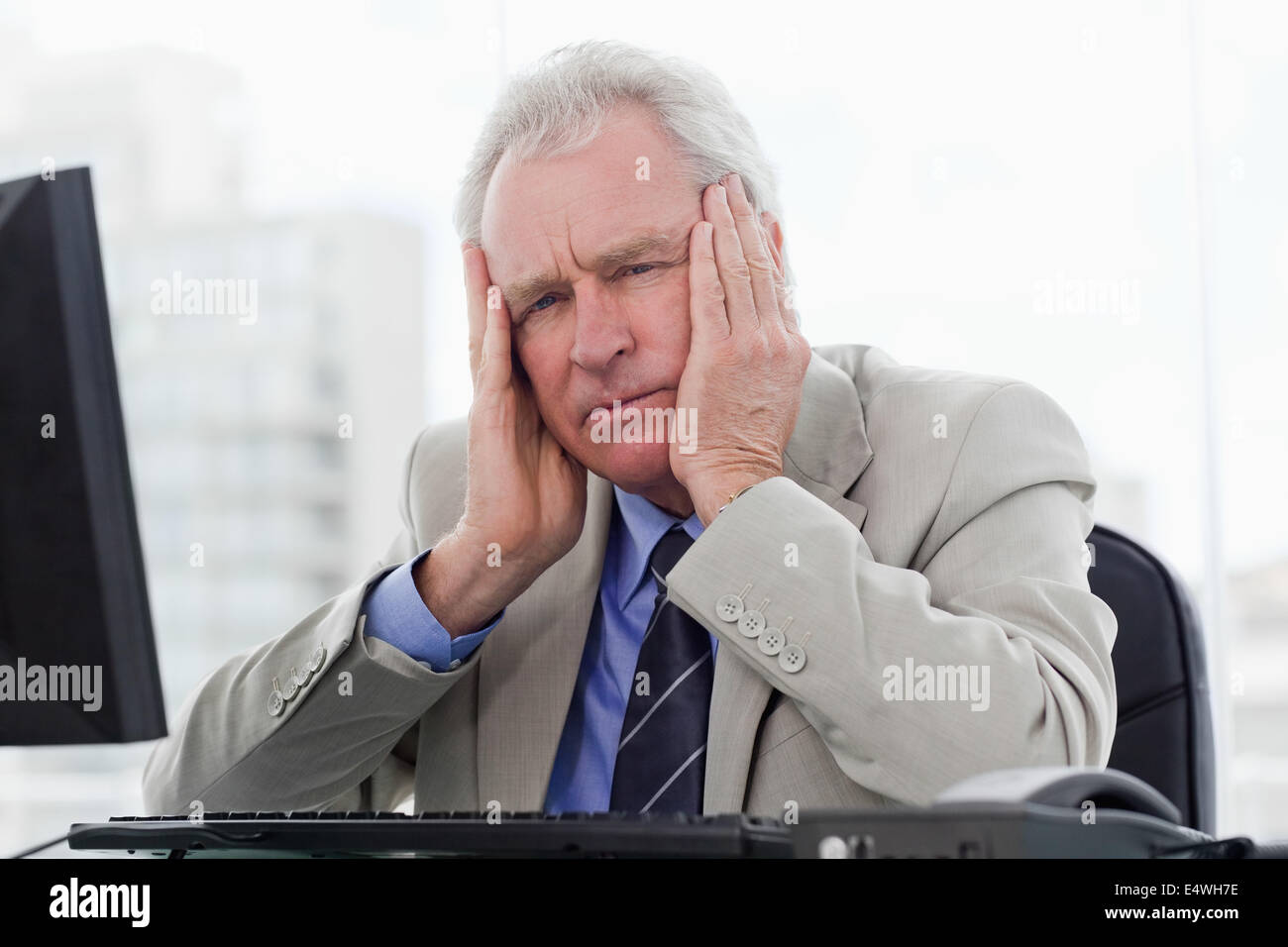 Tired senior manager working with a monitor Stock Photo - Alamy