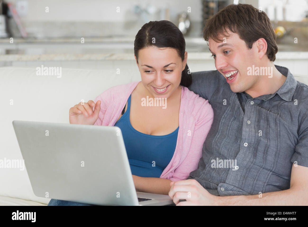 Two people having fun with the laptop Stock Photo - Alamy