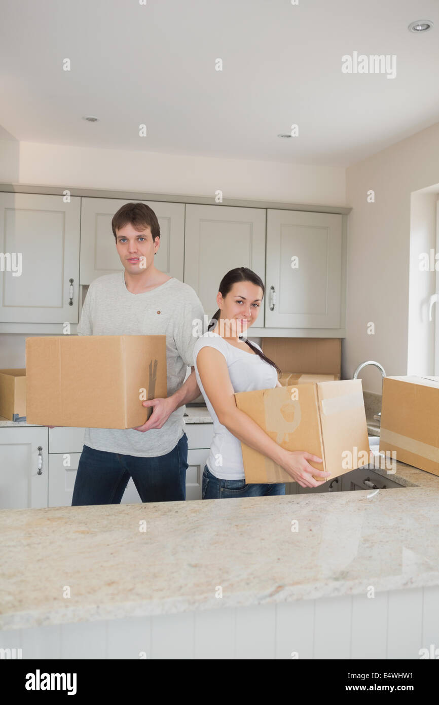 Two people standing in the kitchen Stock Photo - Alamy