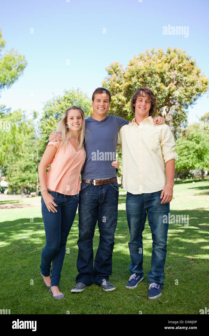 Three smiling students standing Stock Photo - Alamy