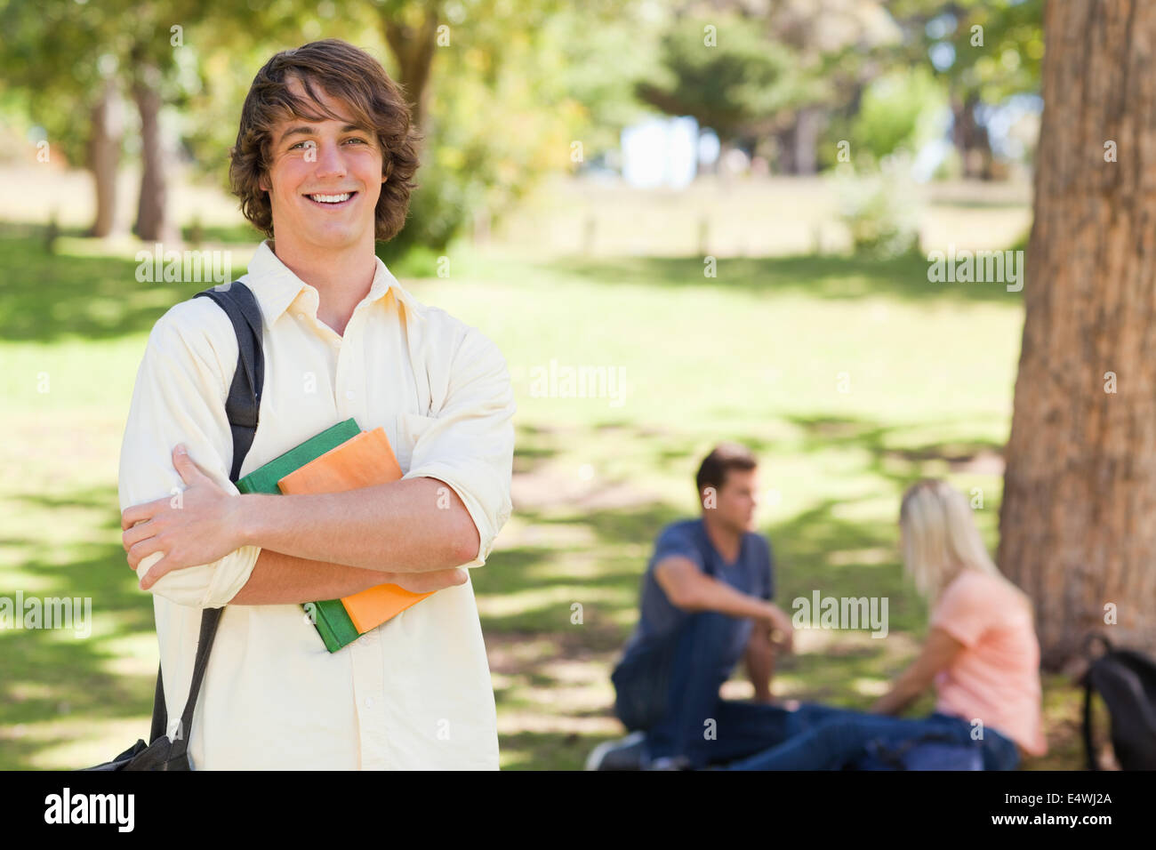 Young man posing with textbook Stock Photo - Alamy