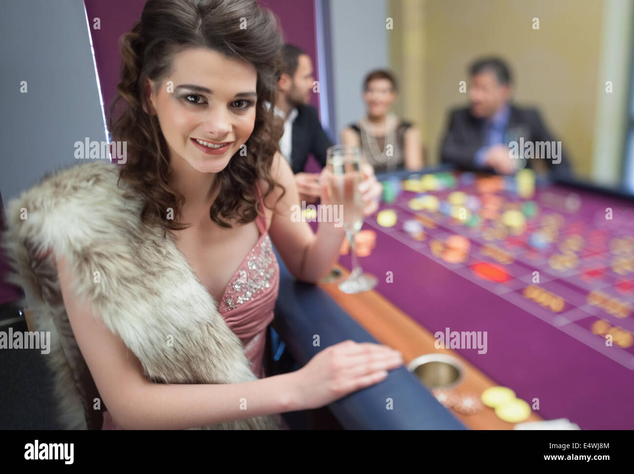Woman in fur stole at roulette table Stock Photo - Alamy