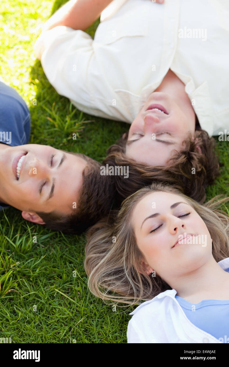 Three happy students resting together Stock Photo - Alamy