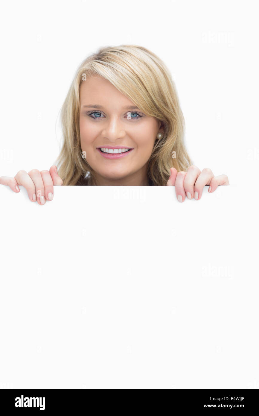 Woman looking above the poster Stock Photo - Alamy