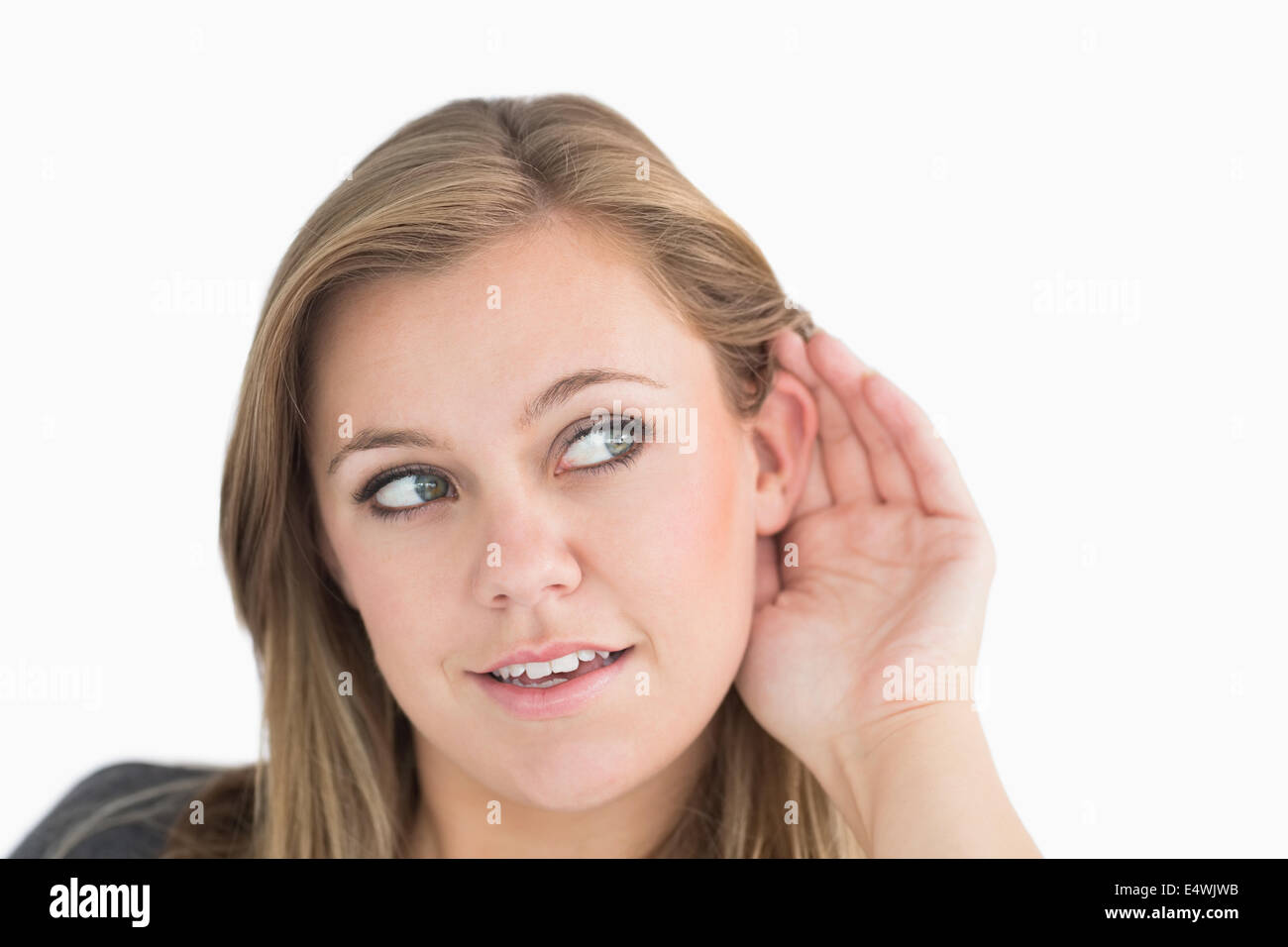 Woman making the sign of listening Stock Photo - Alamy
