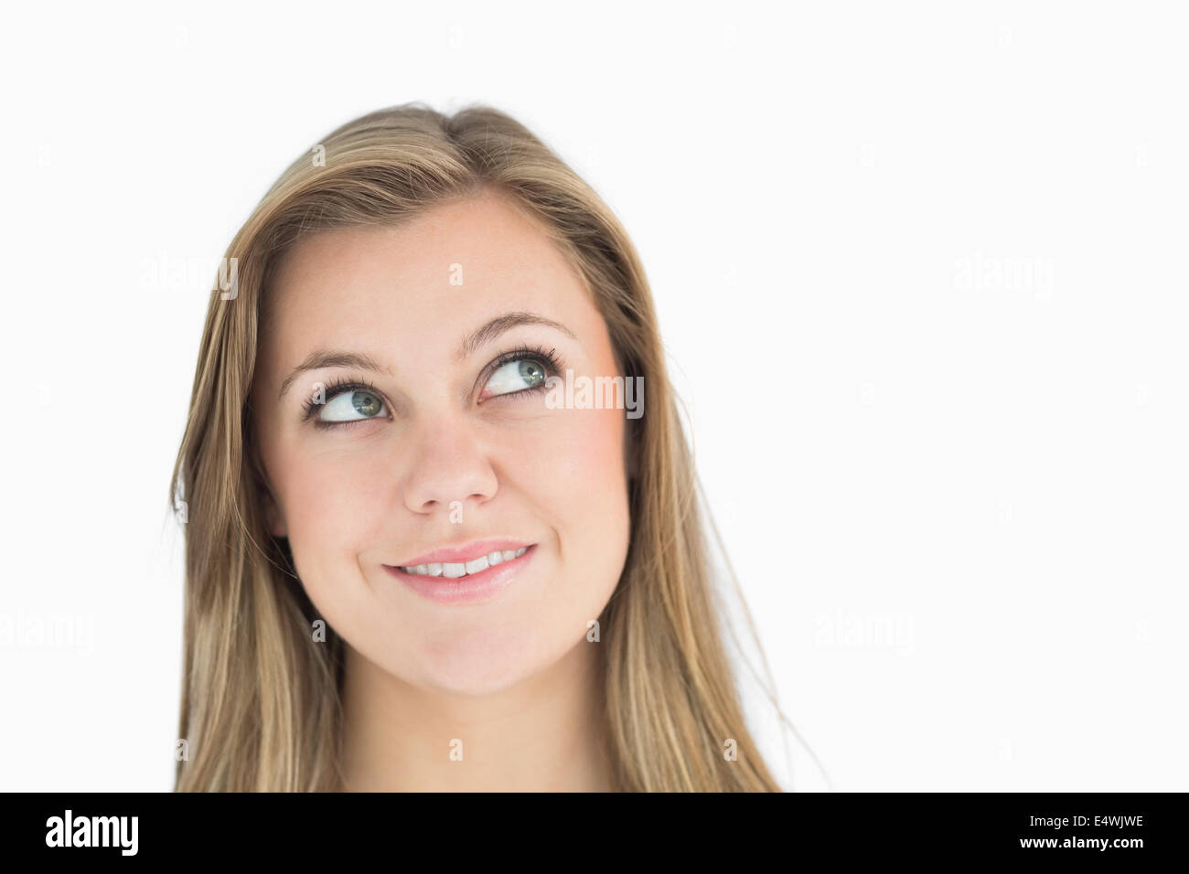 Thoughtful blonde woman smiling Stock Photo - Alamy