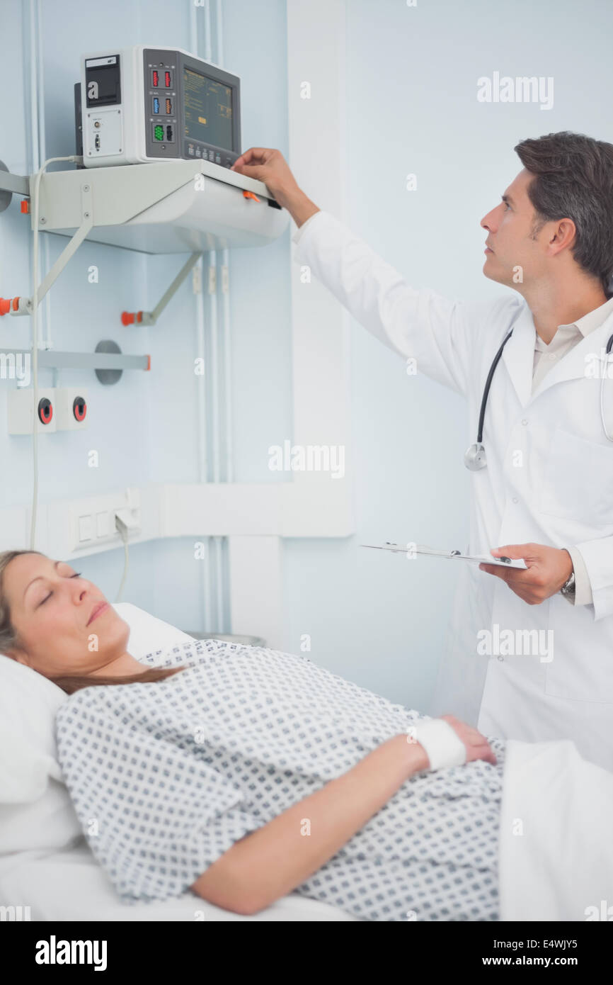 Doctor adjusting a monitor Stock Photo - Alamy
