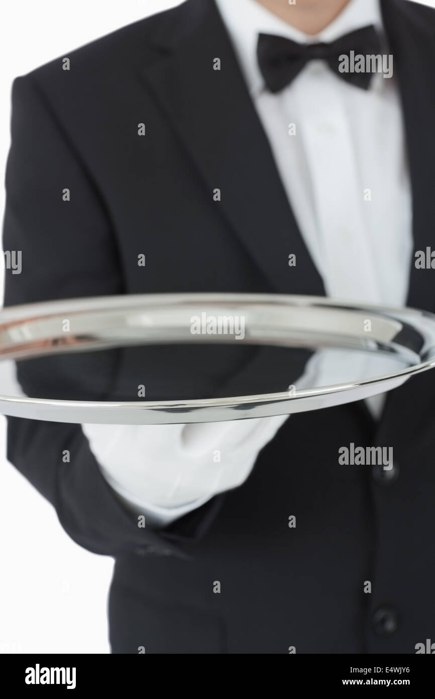Waiter holding silver tray Stock Photo - Alamy