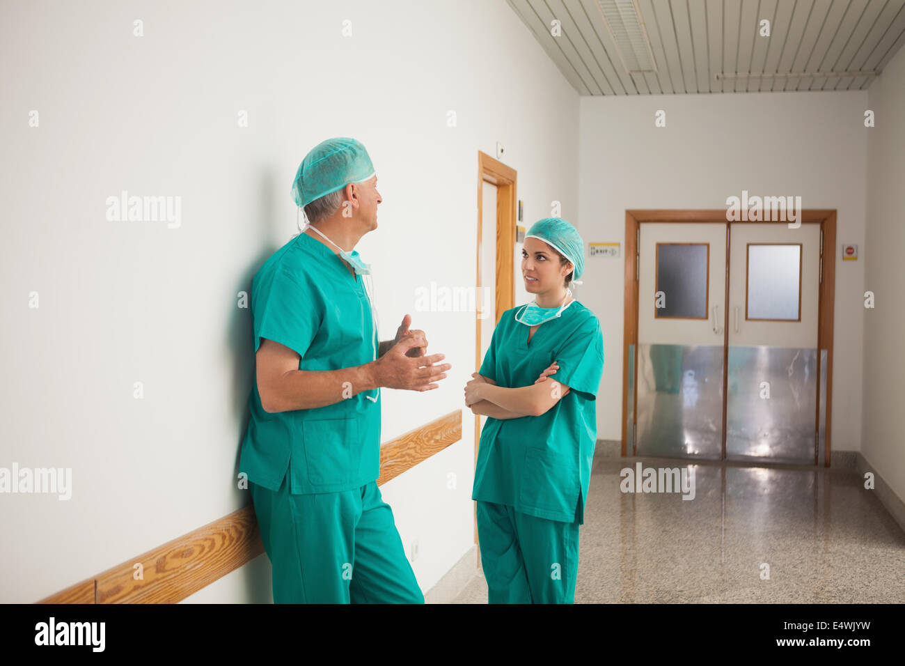Surgeons talking in the corridor Stock Photo - Alamy