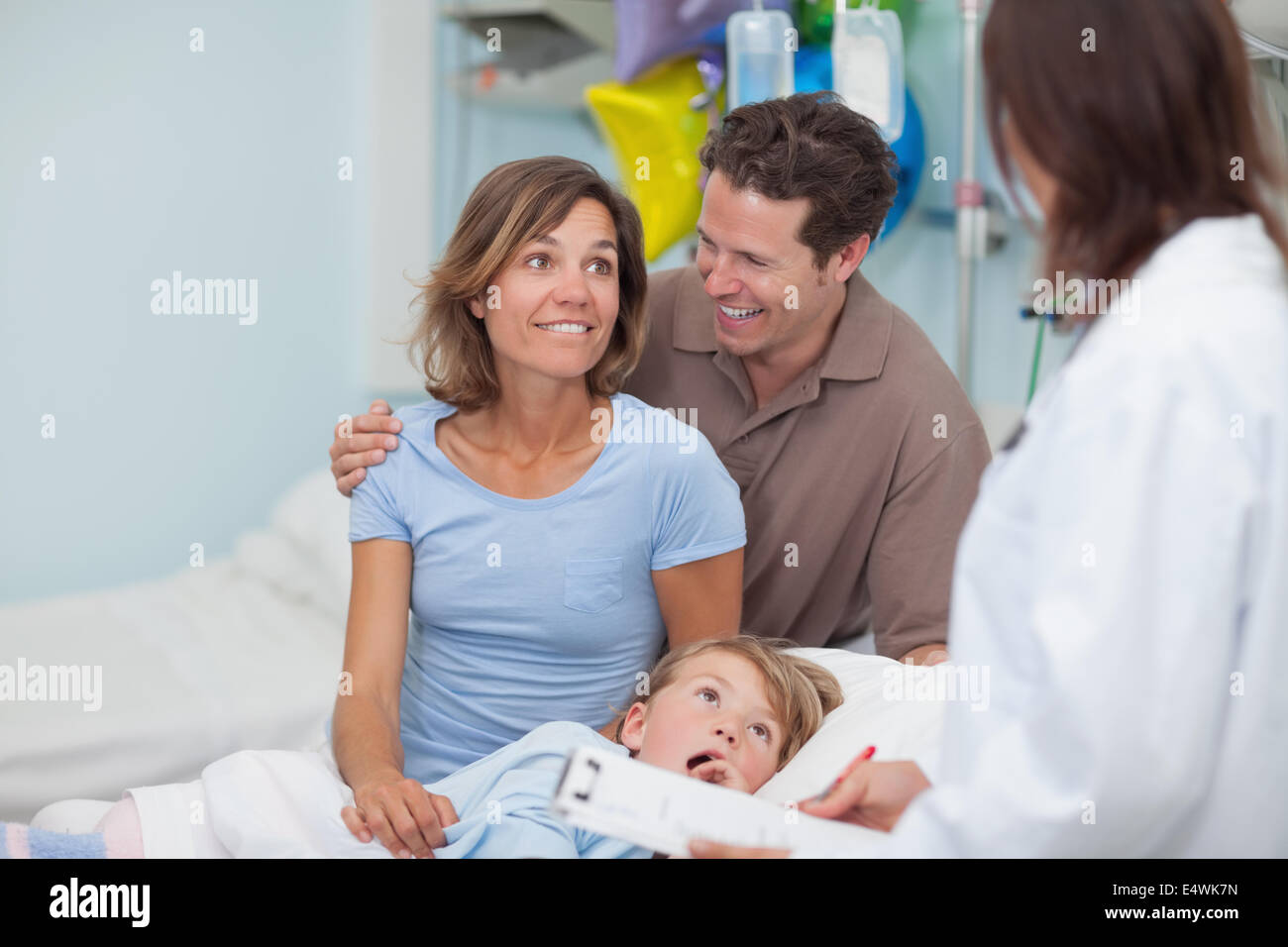 Smiling parents next to a doctor Stock Photo - Alamy