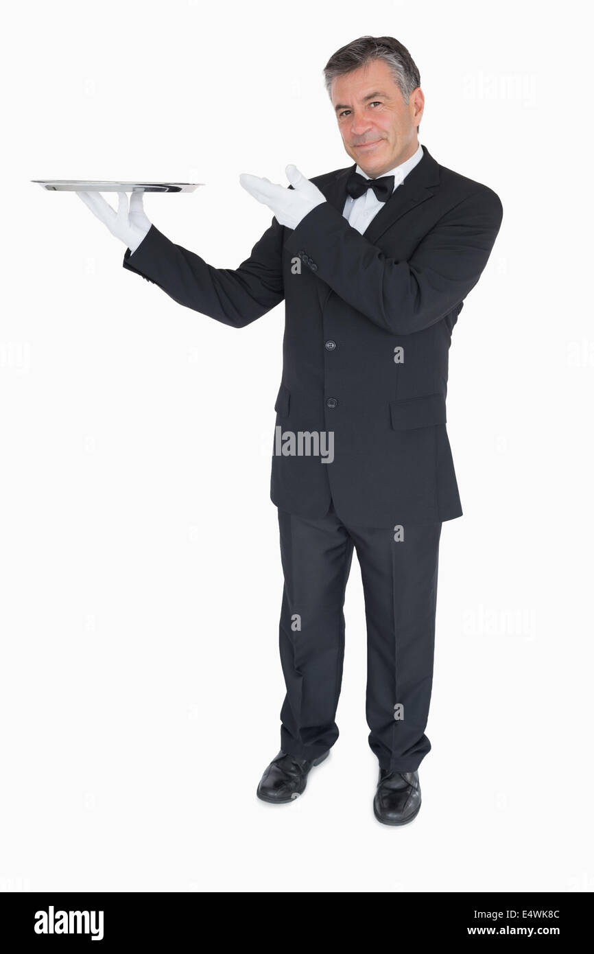 Happy waiter presenting a tray Stock Photo - Alamy